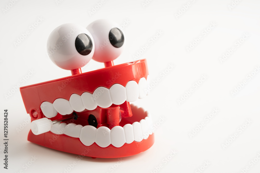 Tooth funny toy denture red color jaw and eye on white background with ...