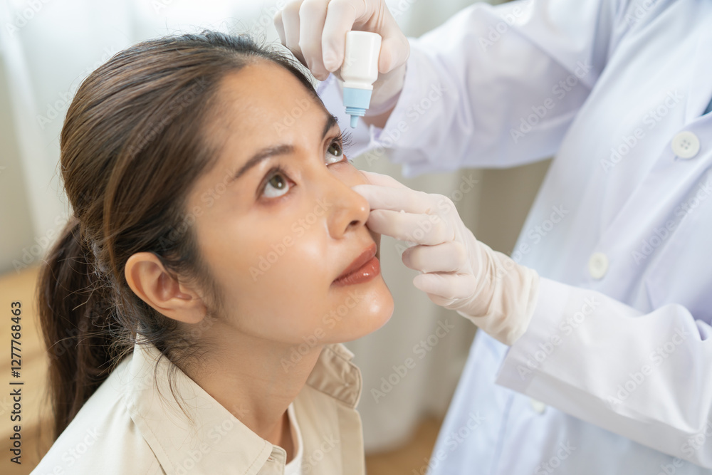 Health care concept, eye doctor eye drops to asian young woman patient ...
