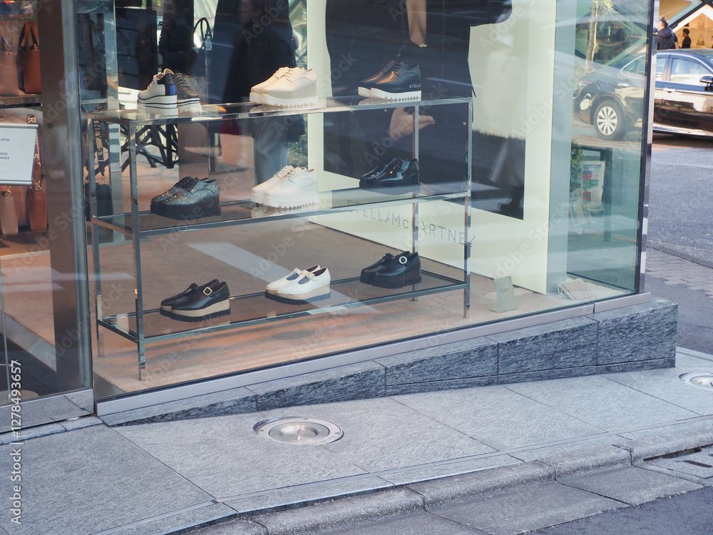 TOKYO, JAPAN - January 9, 2025: Footwear on display in the window of a ...