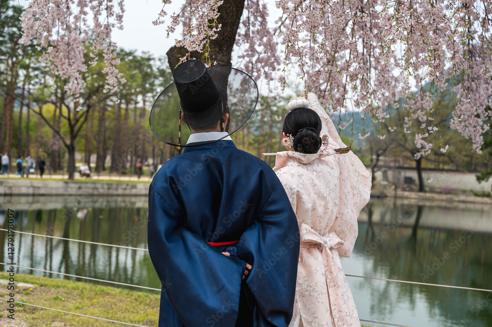 Back view Korean man and woman in colorful traditional Hanbok costumes ...