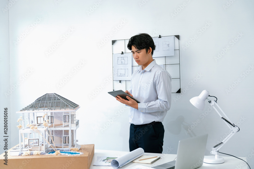 Professional handsome asian project manager using tablet to check house ...