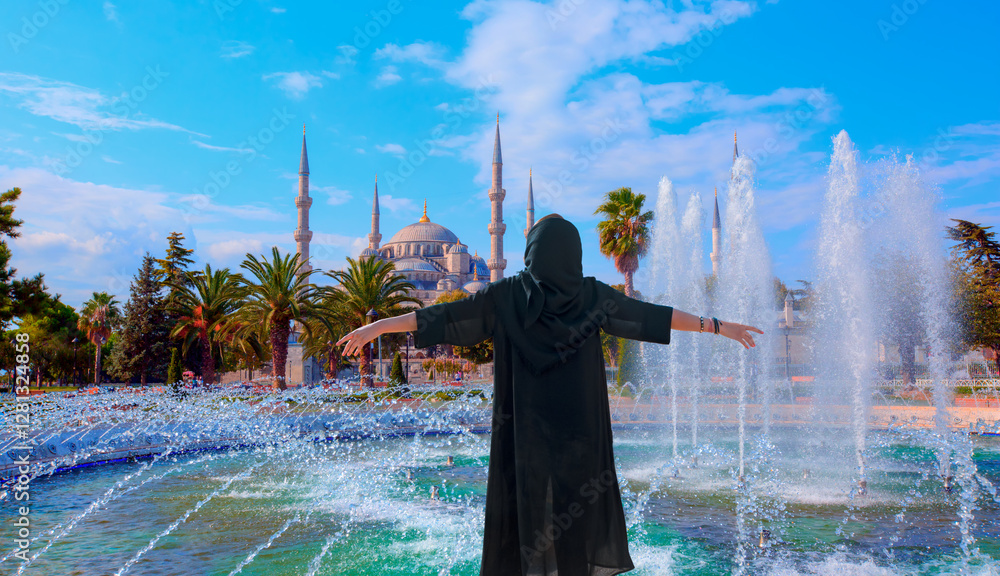 Young girl in traditional abaya clothes enjoying the view Blue Mosque ...