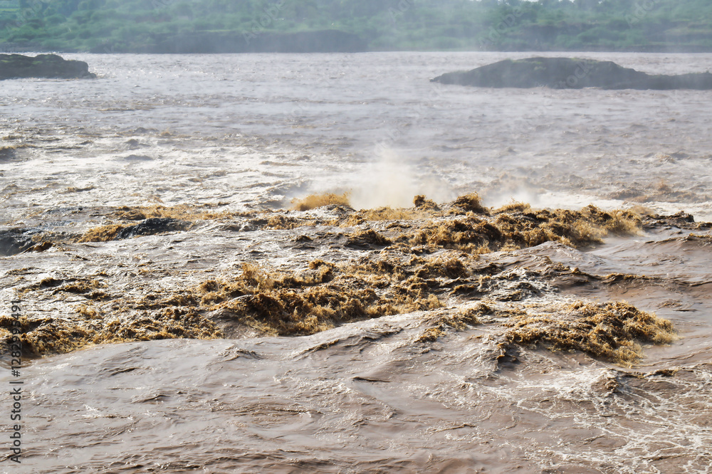 Strong currents and swirling water display the effects of heavy rain on ...