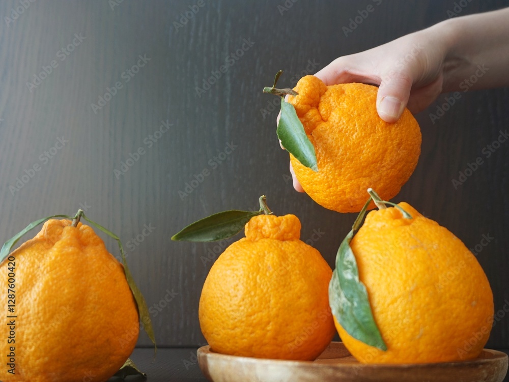 The farmer who grew the Hallabong fruit puts it on the table. Hallabong ...