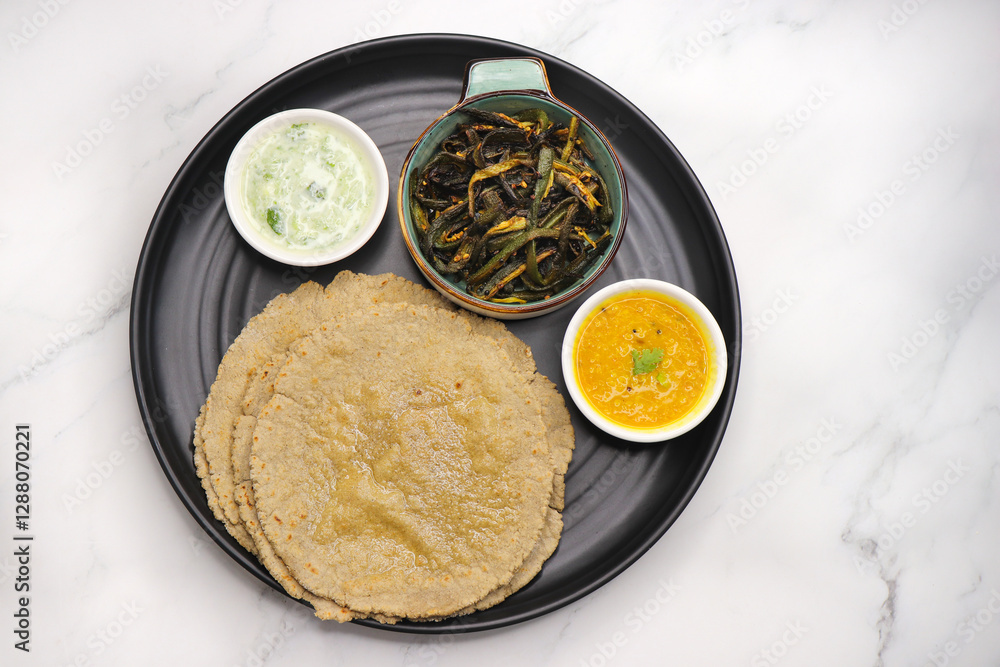 Roti and Sabzi. Indian vegetarian Thali includes bhindi fry, yellow ...