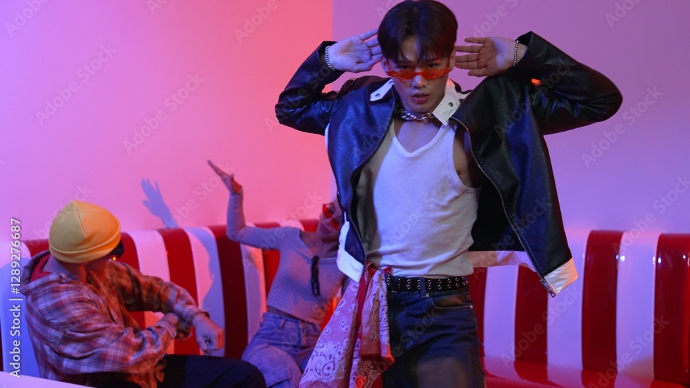 Asian man standing and dancing with pop music while multicultural ...
