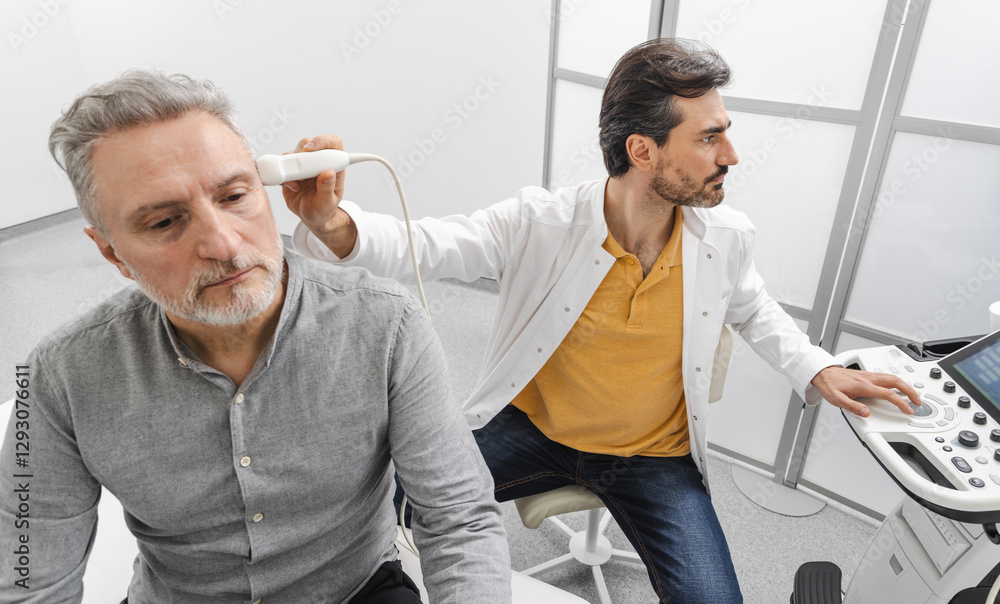 Experienced ultrasound specialist carefully analyzes structure of neck ...