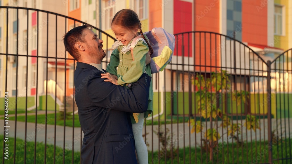 child with school backpack runs into hands his father, school lesson ...