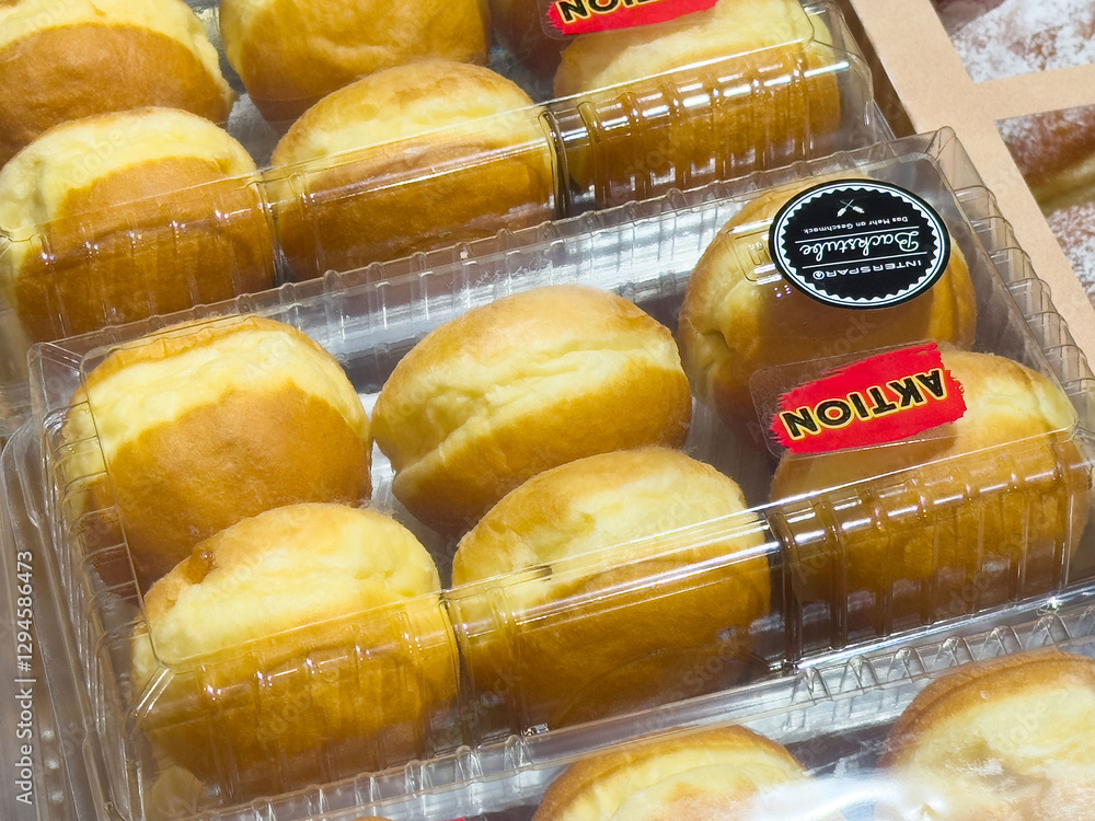 Packaged fresh donuts with custard filling in clear plastic containers ...