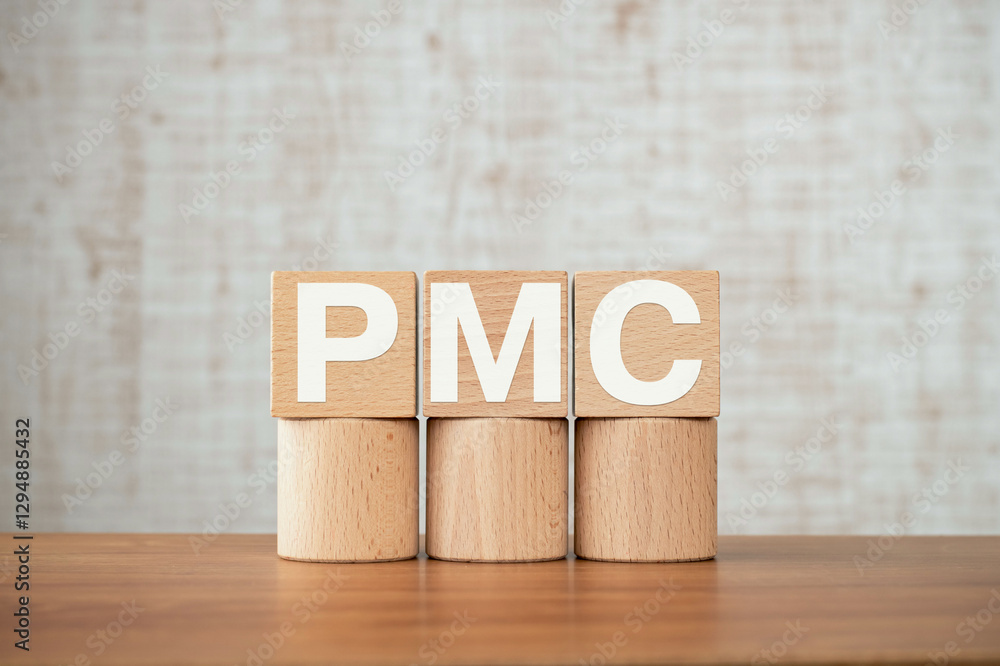 There is wood cube with the word PMC. It is an abbreviation for Private ...