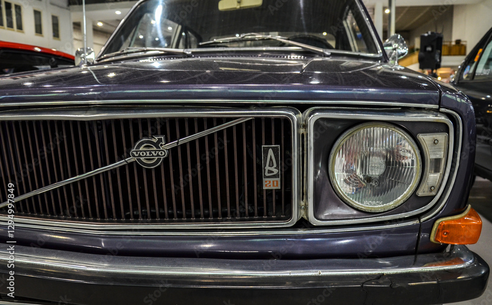 Front of a classic Volvo 142 Series car. The dark blue paint, prominent ...