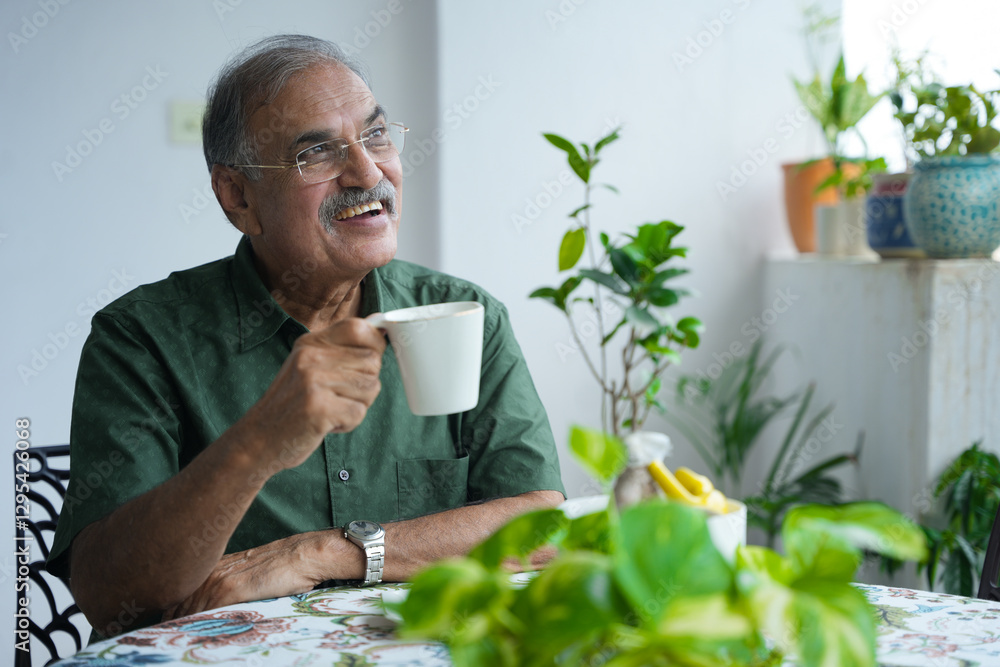 Happy retired senior indian man in 60s drinking morning tea or coffee ...