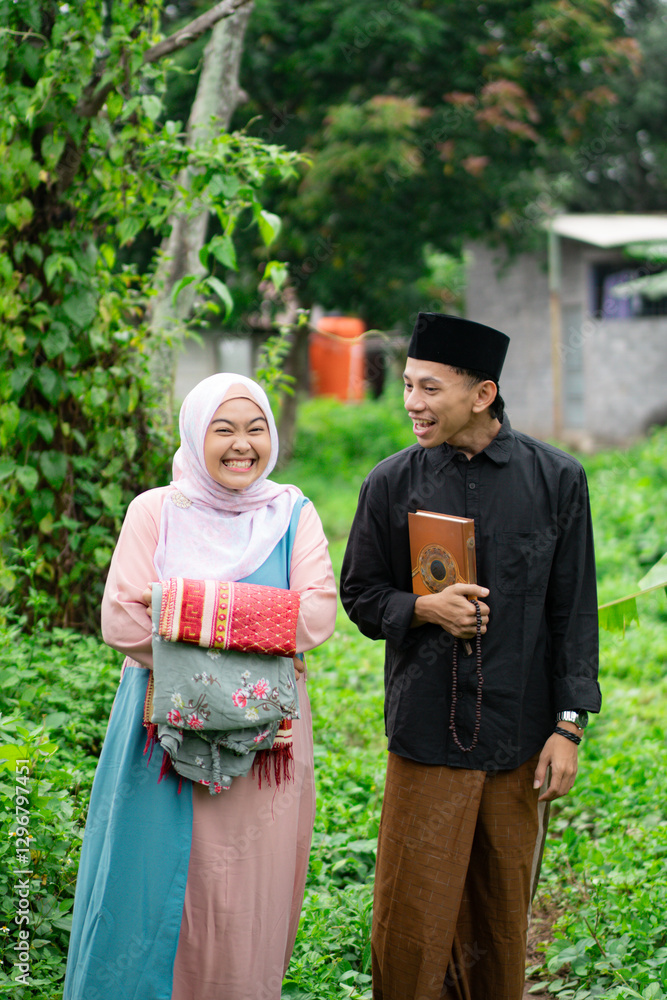 Muslim male students and Muslim female students wearing hijabs walk ...