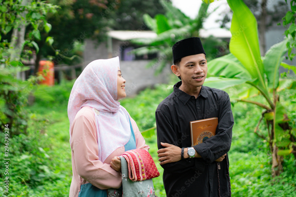 Muslim male students and Muslim female students wearing hijabs walk ...