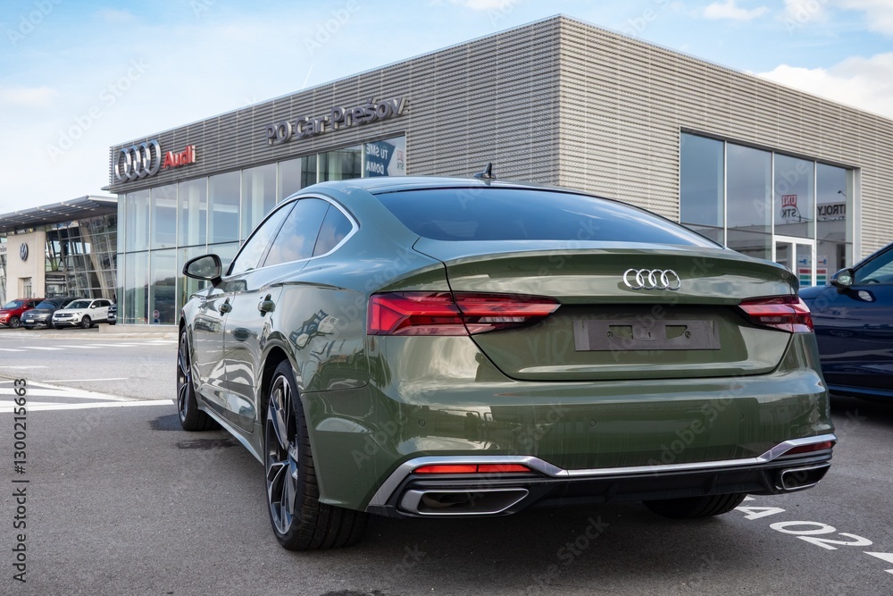 Audi A5 Sportback F5 green saloon car parked in front of dealership ...