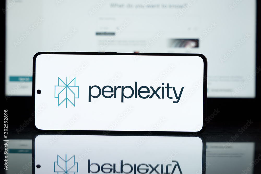 Smartphone displays Perplexity logo. Website screen blurred in ...
