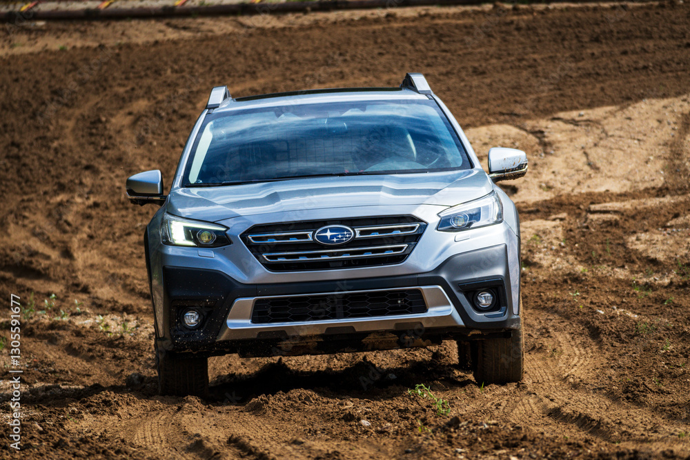 Subaru Outback off-road SUV driving in mud in nature off-road. Driving ...