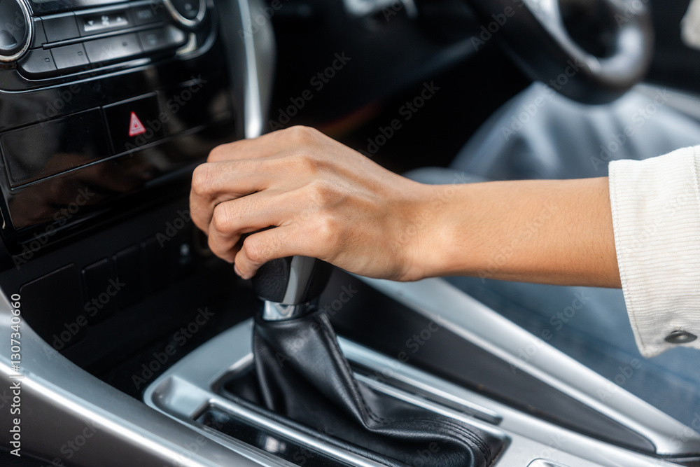 Young asian woman getting new car and his hand control the stick shift ...