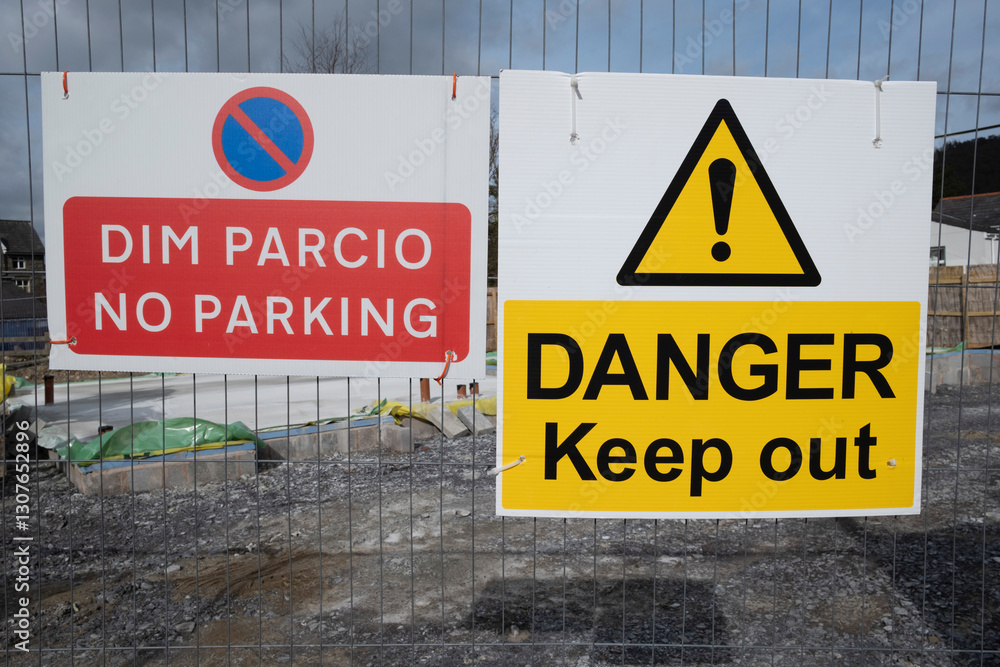 Warning signs, 'No Parking,' in English and Welsh and 'Danger Keep Out ...