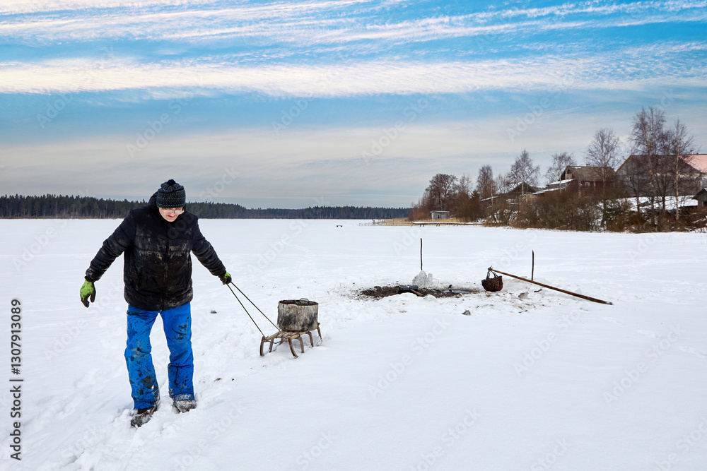 From frozen lake, farmer performs sapropel mining, using pole to scoop ...