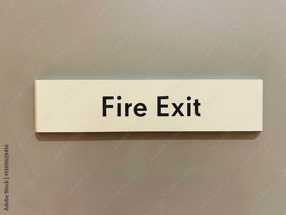 emergency exit sign, A fire exit sign mounted on a wall, indicating an ...