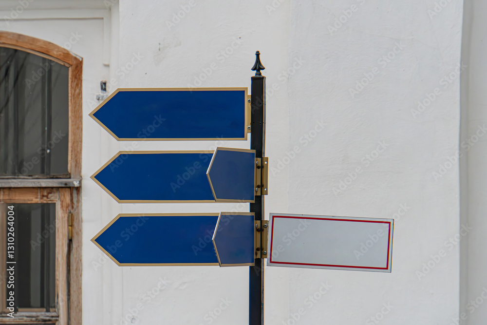 Image of three directional signs mounted on a light post, pointing in ...