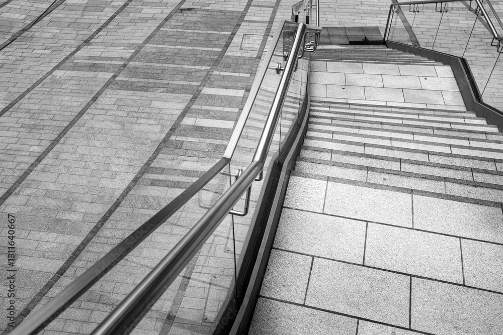 Monochrome urban staircase with glass railing, modern architectural ...