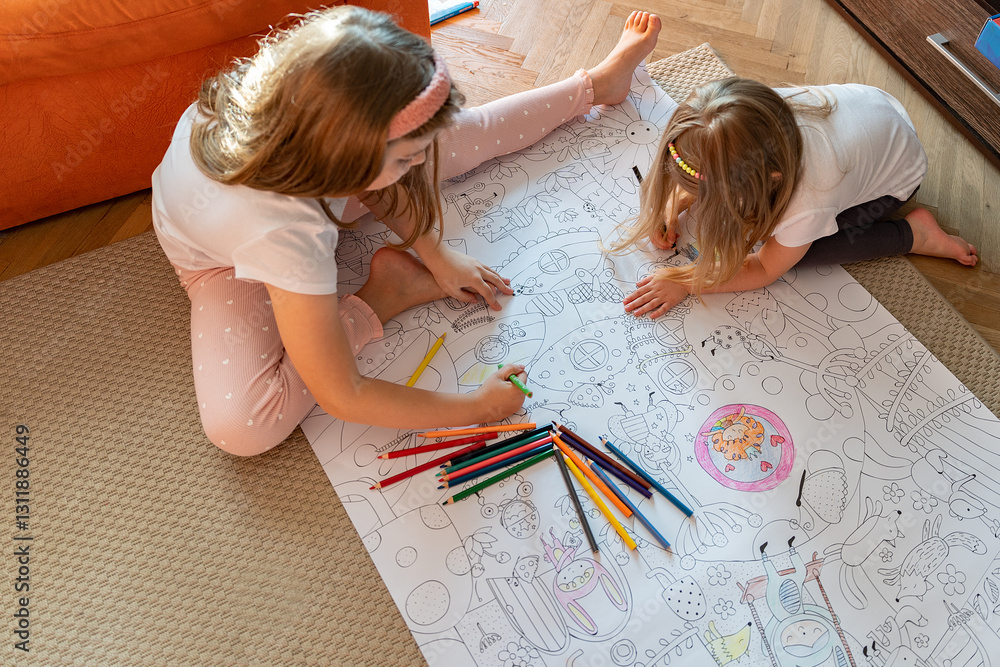 Children girls draw on a large sheet of paper, coloring with colored ...