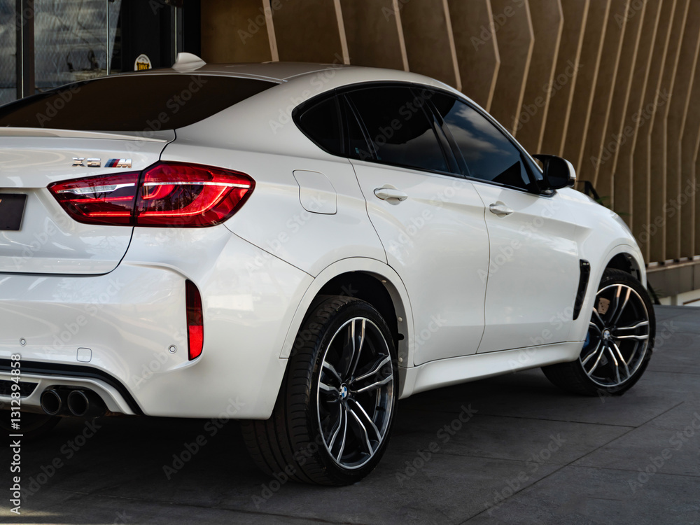 White BWM X6 M Rear end side view, Luxury SUV on modern urban cenario ...