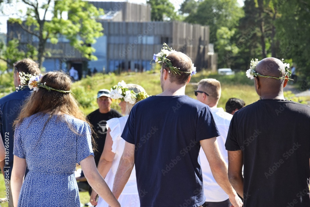 Midsummer festival in Sweden.Different people with wreaths on their ...
