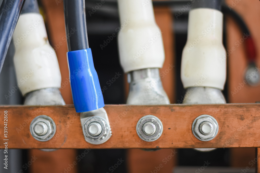 electrical connection.a black electrical wire with a white and blue ...