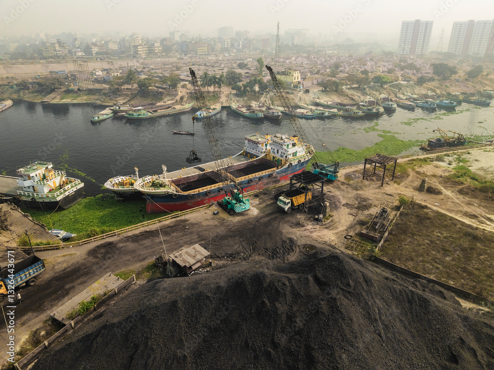 Aerial view of industrial coal factory with ships and river in urban ...