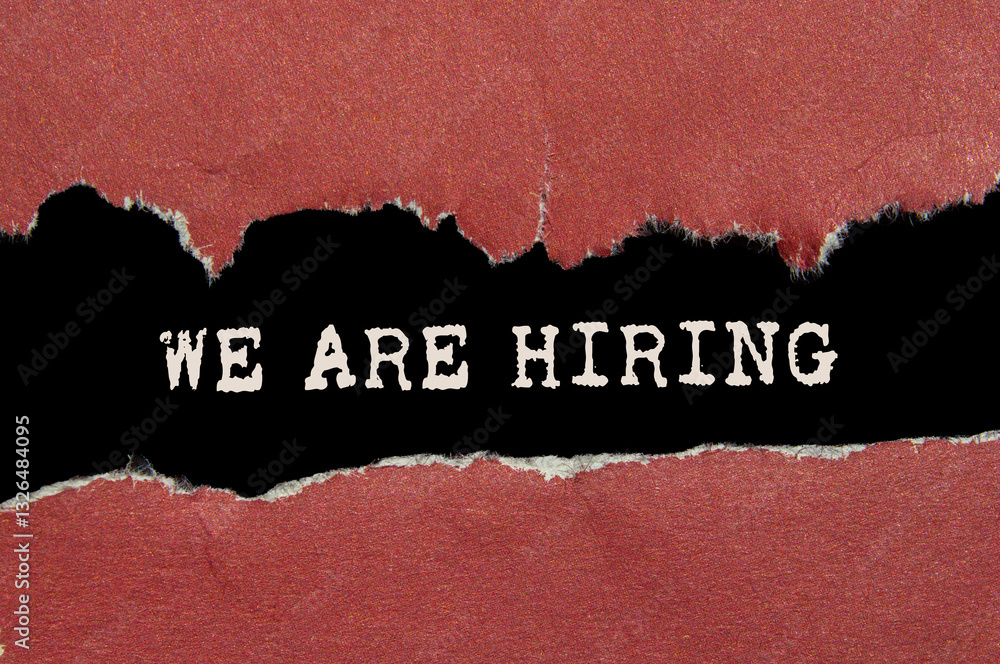 We are hiring message written on ripped torn red paper on black background. Conceptual we are ...