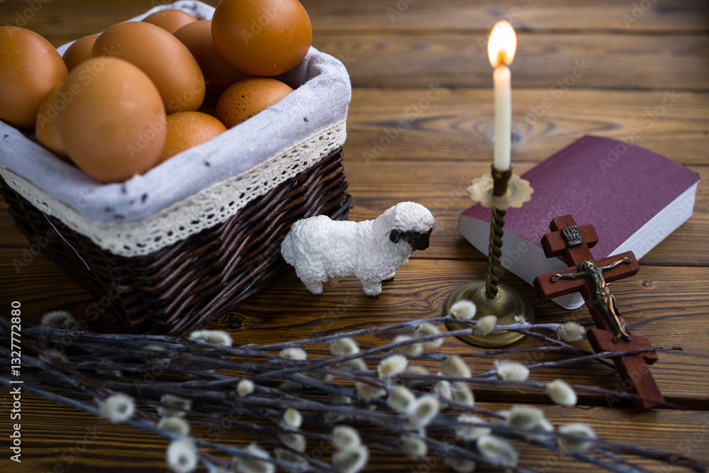 A crucifix on the cross and a prayer book. A lighted church candle and ...