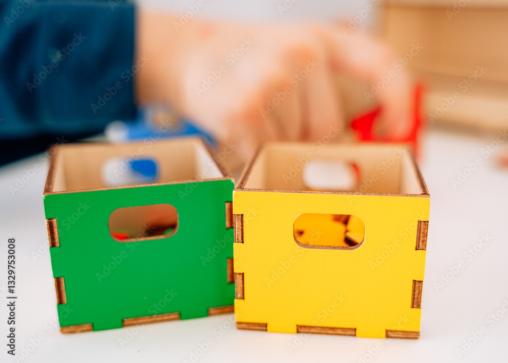 Three boxes: yellow and blue with geometric shapes of different colors ...
