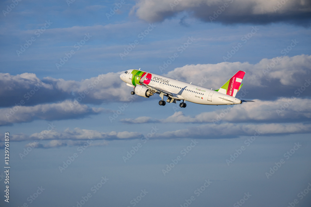 TAP Air Portugal Airbus 320 airplane ascending into clear blue sky ...