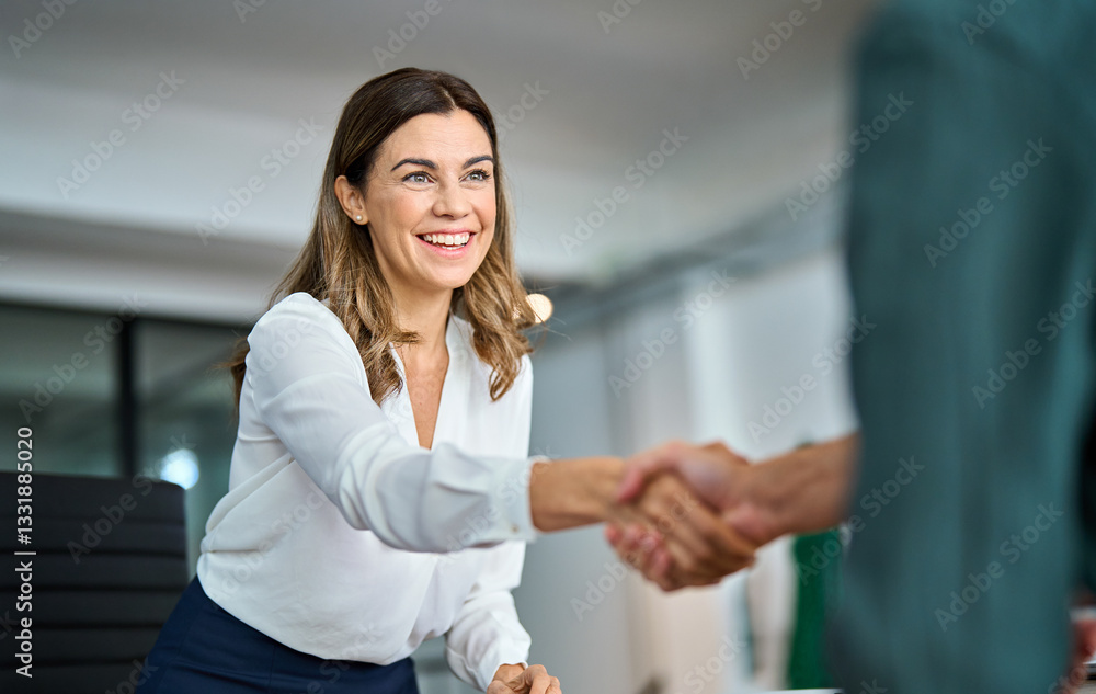 Happy mature professional business woman handshaking partner in office ...