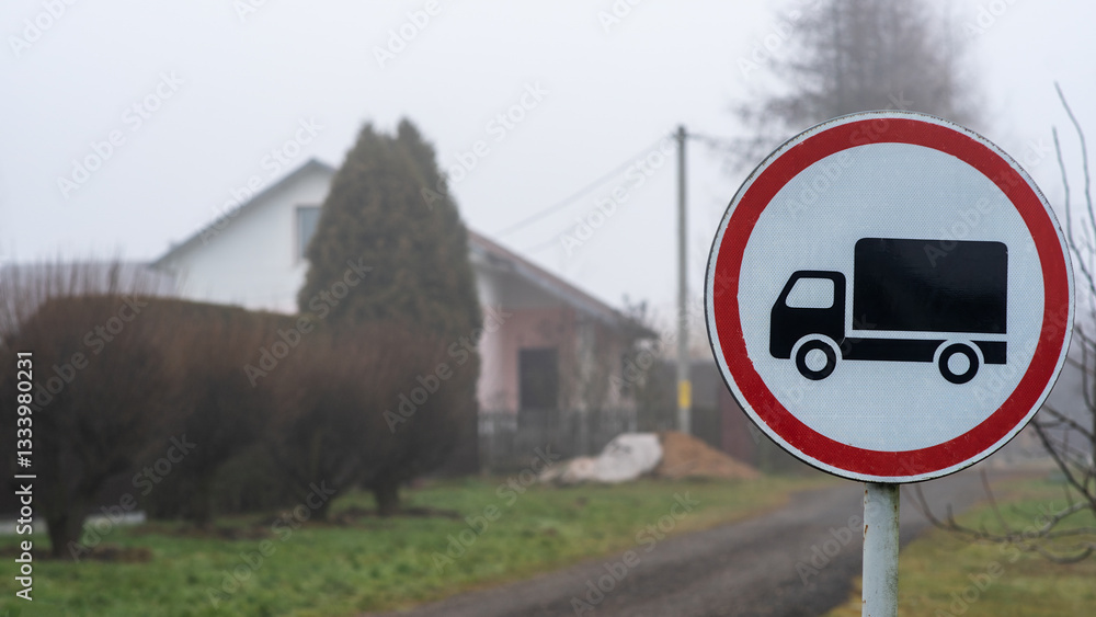 Clear 'No Trucks Allowed' sign in a peaceful residential neighborhood ...