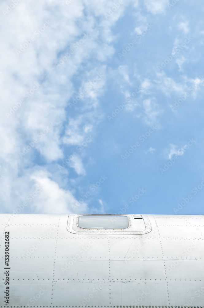 Blue sky frame the aircraft exterior of airplane fuselage with visible ...