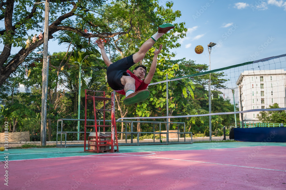 Male Asian Sepak Takraw player kicking Sepaktakraw ratten ball in court ...
