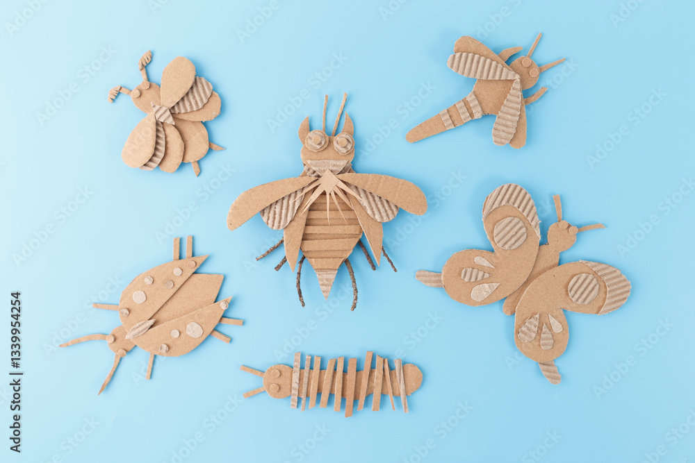 Cardboard insect crafts for kids on blue surface, dragonfly ...