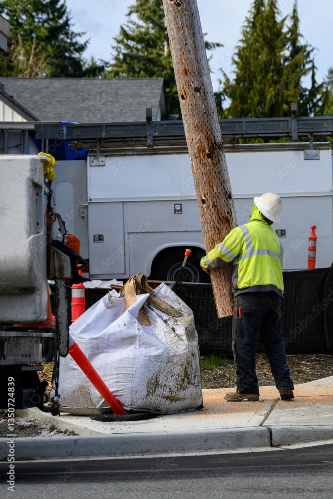 Temporary wood powerline pole cut off and being lifted out of place by ...