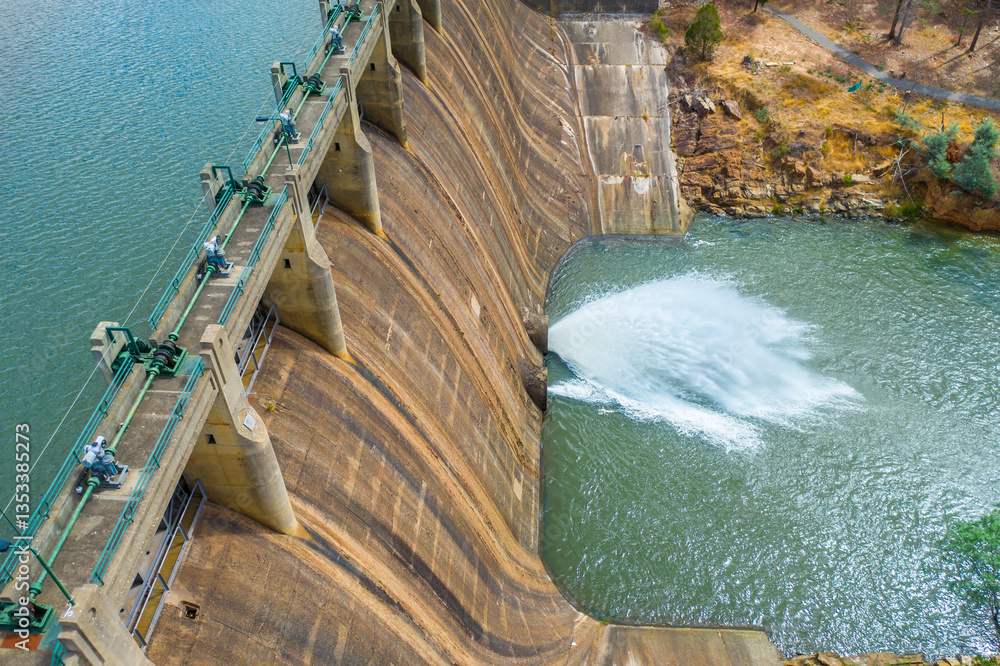 Looking down on a jet of water squirting from the bottom of a dam wall ...