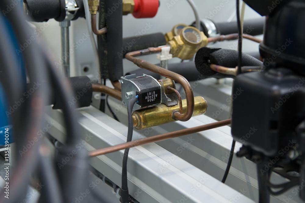 Detailed view of HVAC system solenoid valve with copper tubing and ...