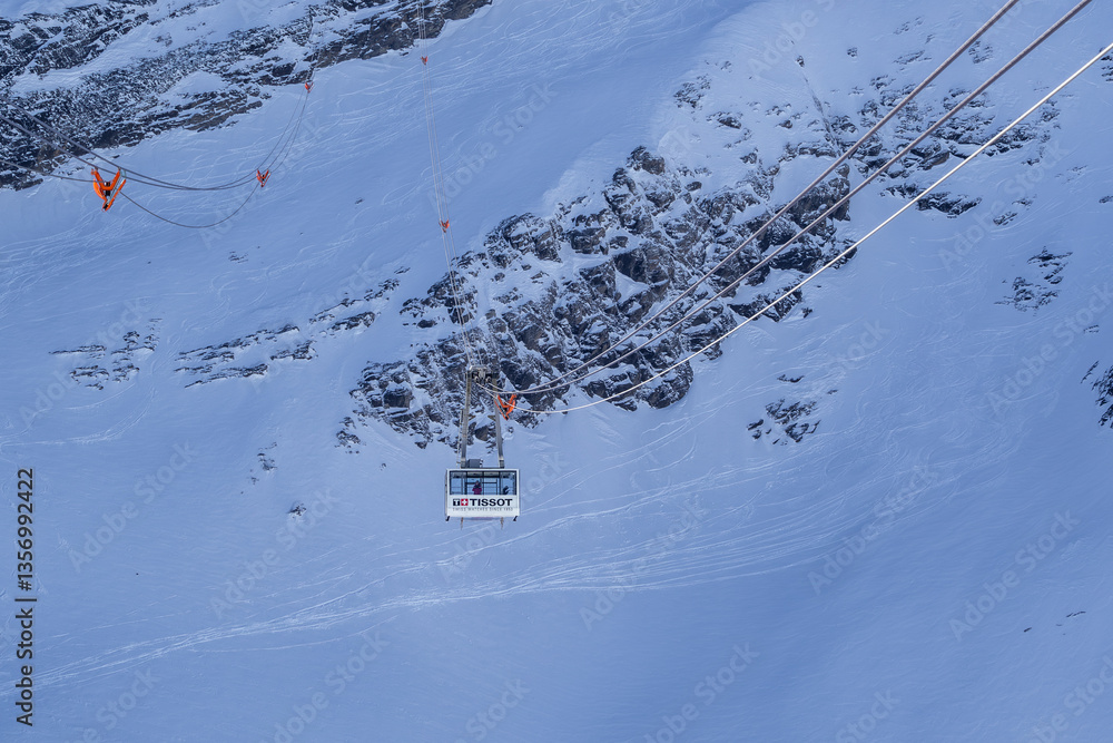 Mountain cable car with passengers to Glacier 3000 summit, featuring ...