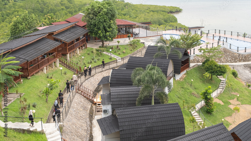 Hillside resort with modern curved-roof cottages and traditional wooden ...