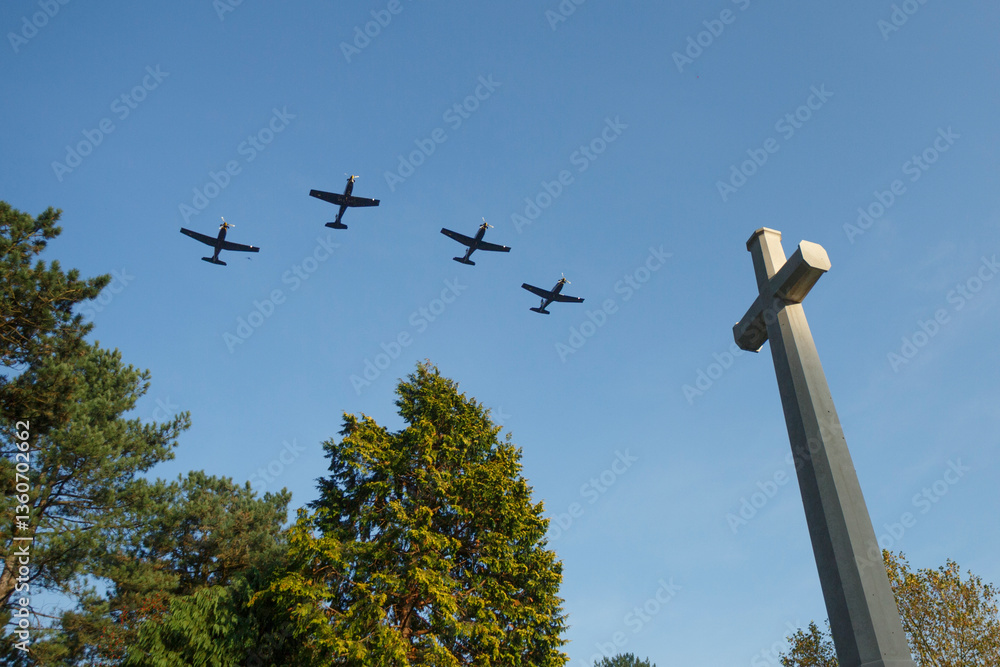 Five aircraft perform a flyover during a memorial ceremony at a ...