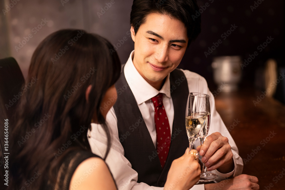 Stylish man in formal attire looking at his partner while toasting ...