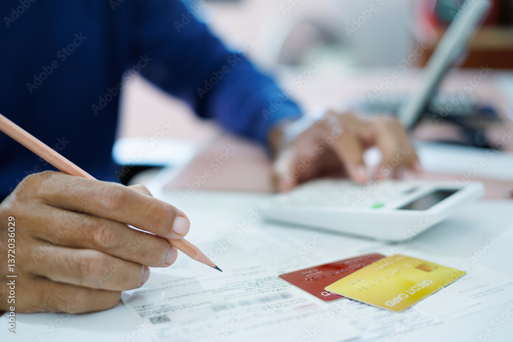 asian man calculate monthly expenses from receipt and many bill of ...