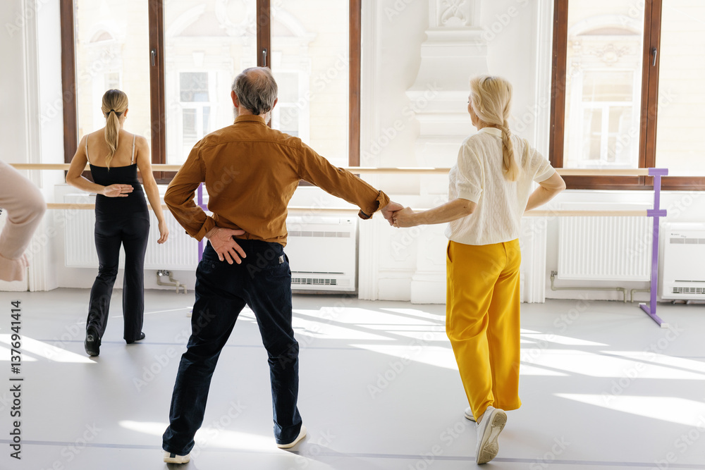 Back view of old couple holding hands training with dance teacher Stock ...